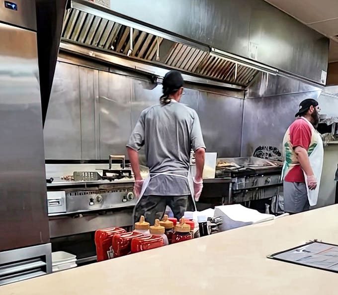 The kitchen crew works their magic in full view, a well-choreographed dance of spatulas and sizzling pans.