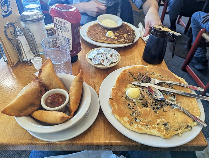 A feast for the eyes and stomach—empanadas and corn pancakes share table space in a spread that showcases the diverse flavors of Colombian cuisine.