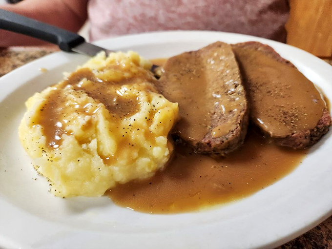 Meatloaf and mashed potatoes swimming in savory gravy &ndash; the kind of plate that makes you want to call your boss and take the afternoon off.