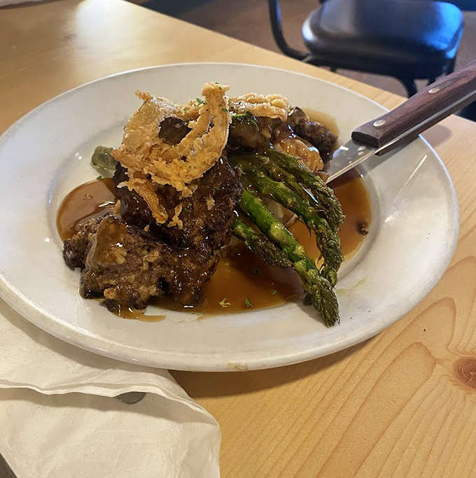 Meatloaf that would make grandma jealous, swimming in savory gravy alongside fresh asparagus&mdash;comfort food elevated to an art form.