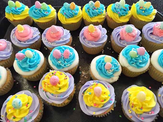 Cupcakes in Easter egg colors lined up like edible happiness, each one a tiny celebration waiting to happen.
