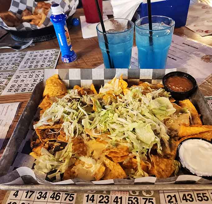 Nachos piled high enough to require architectural planning and a strategic eating approach.