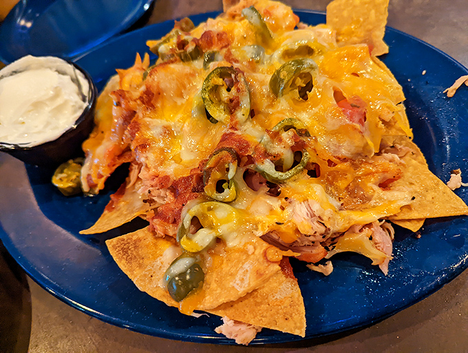 Not your average ballpark nachos—these loaded triangles of joy support more toppings than seems physically possible without architectural intervention.