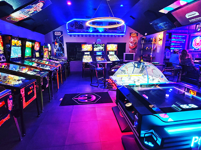 The neon-bathed arcade room pulses with electric energy, where pinball machines stand like soldiers awaiting their next commander.