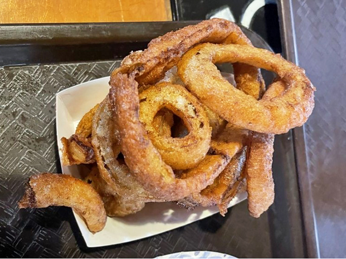 Onion rings that deserve their legendary status. Thick-cut, beer-battered, and fried to audible crunchiness, these aren't mere sides, they're co-stars.