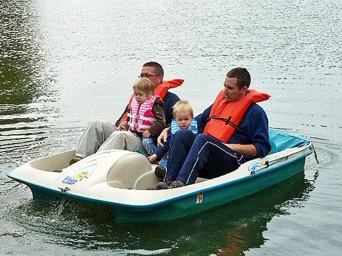 Family memories form on the lake's surface as pedal boats create ripples that will echo in childhood recollections for decades to come.
