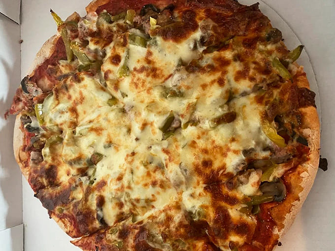 The Works pizza comes loaded with enough toppings to make the table tilt slightly &ndash; green peppers and Italian sausage playing the starring roles.