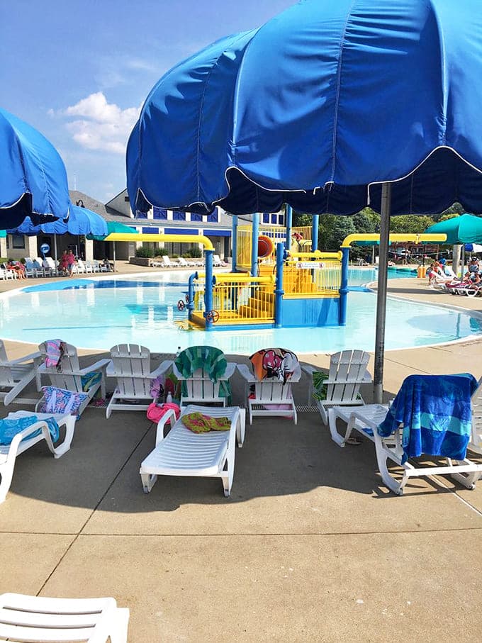 Vibrant umbrellas create islands of shade where weary swimmers recharge before their next aquatic adventure.