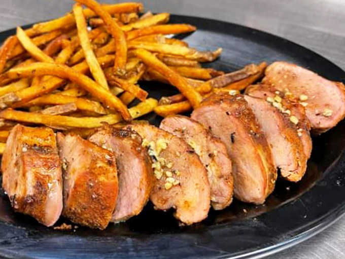 Juicy medallions of perfectly seasoned pork tenderloin that prove Carmie's mastery extends beyond just beef.