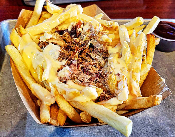 Comfort food elevated &ndash; golden fries smothered in cheese and topped with tender pulled pork for an indulgent flavor explosion.
