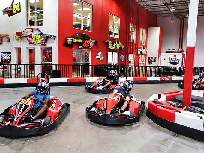 Red karts blur past as drivers lean into turns &ndash; that intense concentration face is the same one used when parallel parking in tight spots.