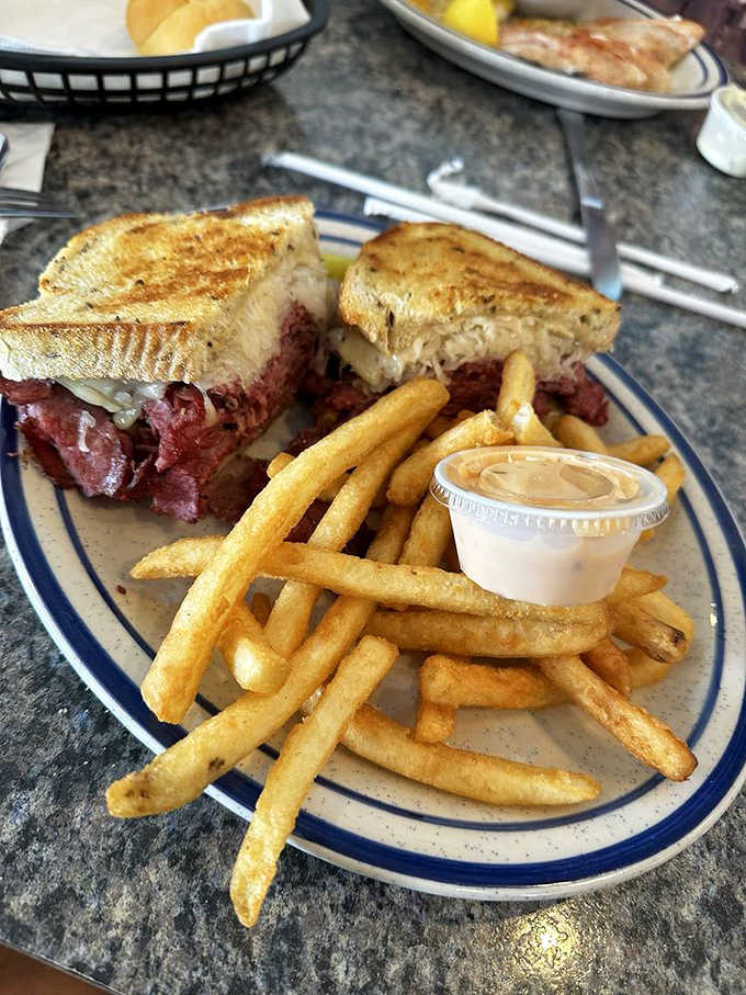 The Reuben: a skyscraper of corned beef and sauerkraut that requires both hands and possibly an engineering degree to eat.