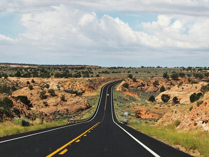 The open road stretches toward the horizon, a perfect metaphor for freedom that car commercials try to capture but rarely achieve.