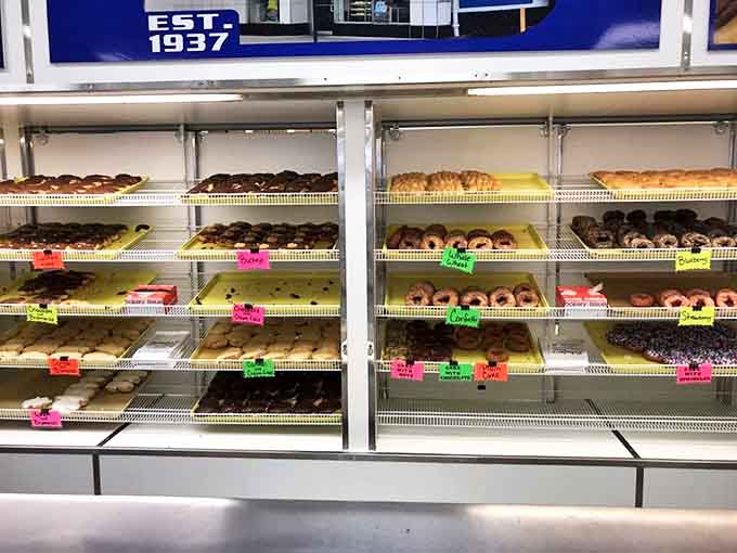 The donut selection stretches as far as the eye can see – a carbohydrate constellation of glazed, frosted, and filled planets orbiting around your sweet tooth.