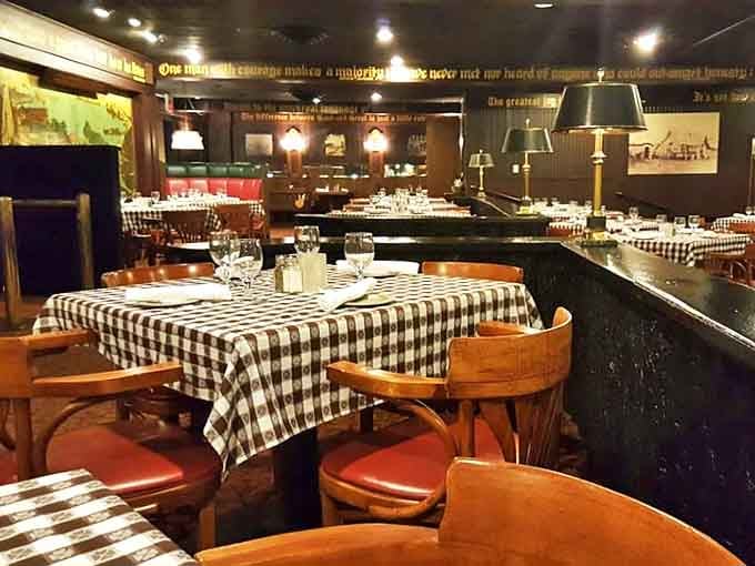 Black and white checkered tablecloths set the stage for memorable meals in a dining room that balances elegance with comfort.
