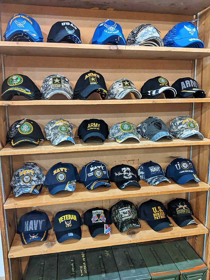 Military caps displayed with respectful precision honor service branches and veterans, the carefully arranged collection drawing both collectors and those with personal connections.