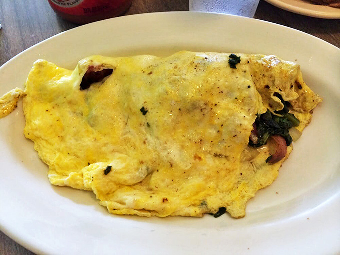 Fluffy pancakes the size of dinner plates arrive ready to soak up butter and syrup, making you question every pancake you've ever eaten before.