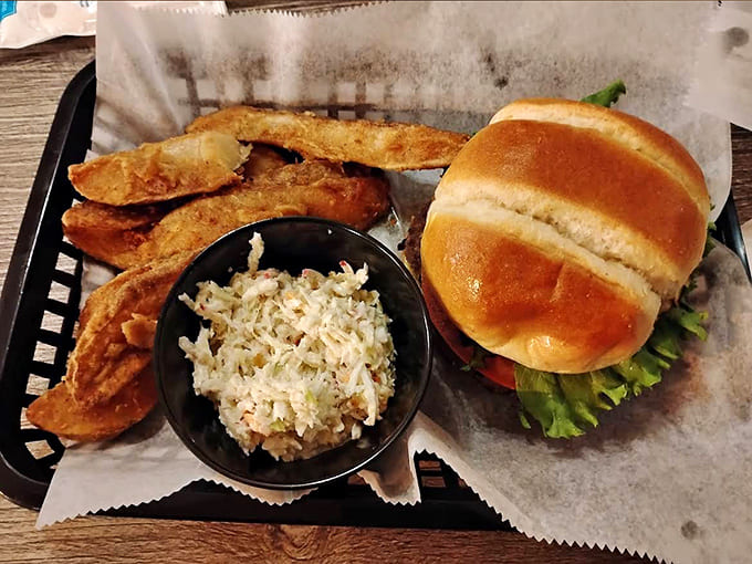This isn't just a burger, it's a monument to beef, nestled in a soft bun with crispy potato wedges standing guard. Napkins required, no exceptions!