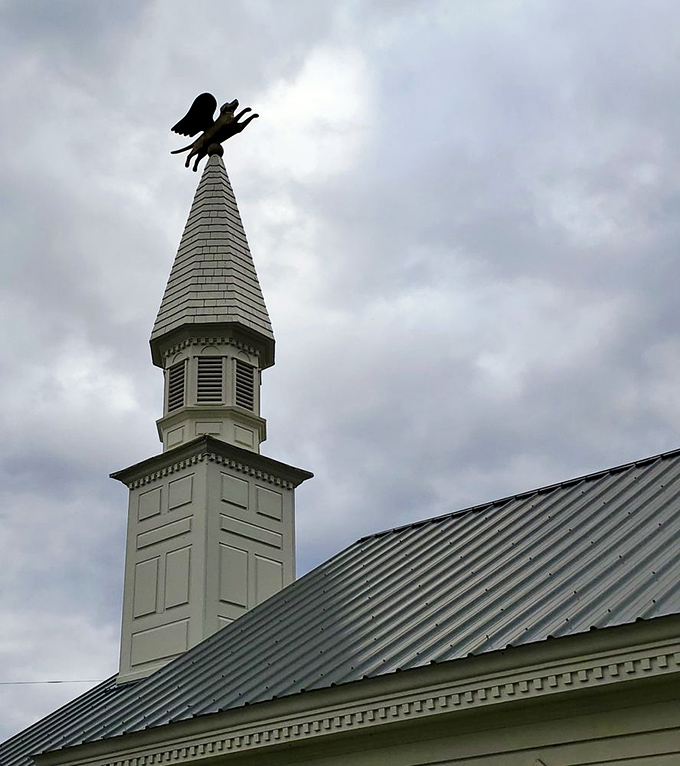 The chapel's steeple reaches toward Vermont's big sky, topped with a golden dog weathervane that keeps watch over this unique sanctuary.