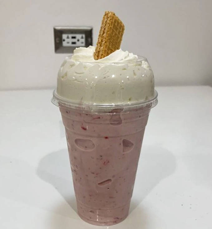 This strawberry milkshake isn't just pink &ndash; it's blushing from all the compliments. The wafer cookie adds that perfect crispy contrast.