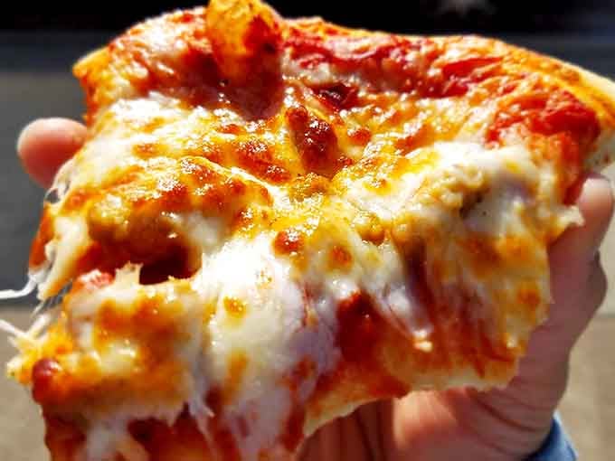 That cheese pull and perfectly crispy crust in a single slice shows exactly why this pizza has earned its legendary status.