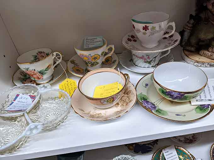 Delicate teacups wait patiently for their next afternoon tea, each floral pattern and gold rim telling stories of genteel gatherings.