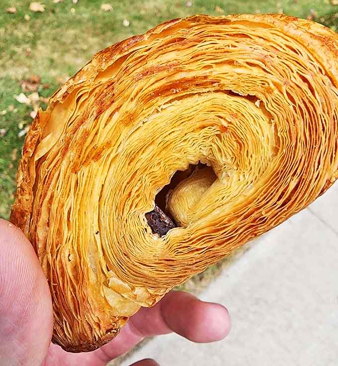 The cross-section of this chocolate croissant reveals the architectural marvel within&mdash;layer upon layer surrounding a chocolate heart of darkness.