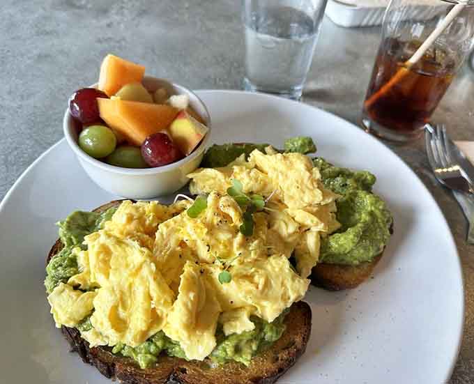 Avocado toast that actually deserves all the hype, topped with creamy scrambled eggs.