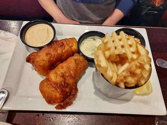 Golden-fried fish arrives with perfectly crispy coating, proving that great fish fry isn't exclusive to Friday nights or Wisconsin supper clubs.