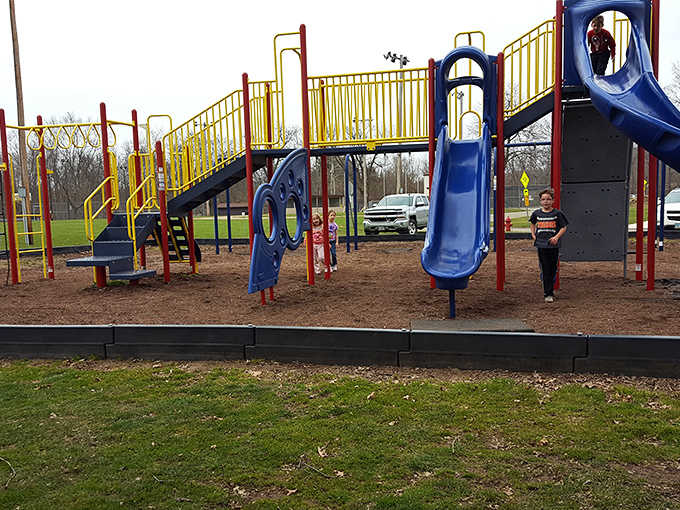 Primary colors pop against blue skies at this playground where kids burn off whatever impossible energy remains after swimming.