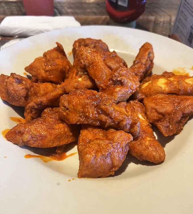 These wings glisten with sauce and promise the kind of finger-licking goodness that requires extra napkins.