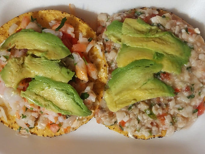 Avocado royalty: Perfectly ripe slices crown these tostadas, adding creamy richness to the fresh, vibrant toppings beneath.