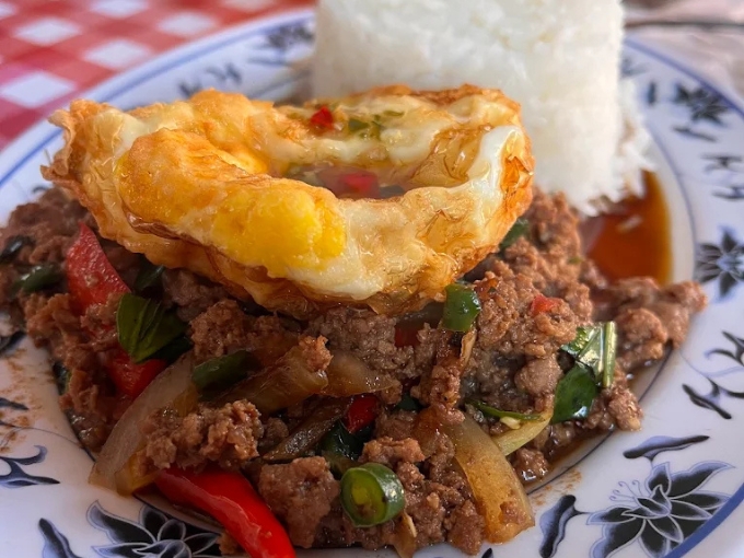 Another angle on Thai basil perfection, the vibrant colors hint at the flavor explosion waiting with each forkful.