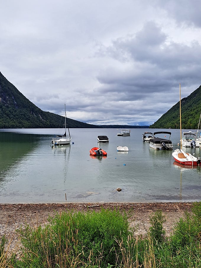 Sailboats dot the waters during summer months, adding perfect pops of color against the dramatic mountain backdrop.