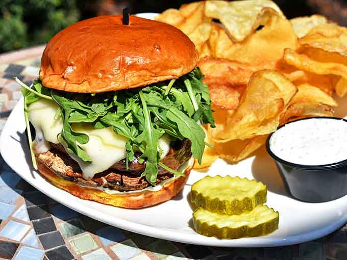 A burger that means business &ndash; perfectly charred outside, juicy inside, topped with melted cheese and fresh arugula on a toasted bun that holds it all together.