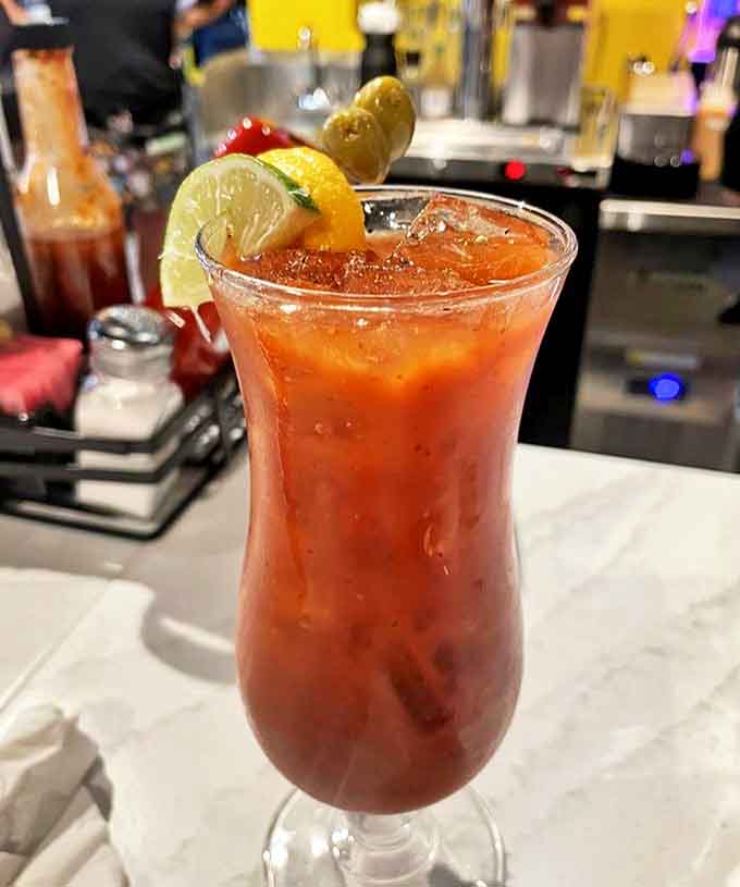 This isn't just any Bloody Mary &ndash; it's a spicy, savory masterpiece garnished with enough goodies to count as an appetizer before your actual breakfast arrives.