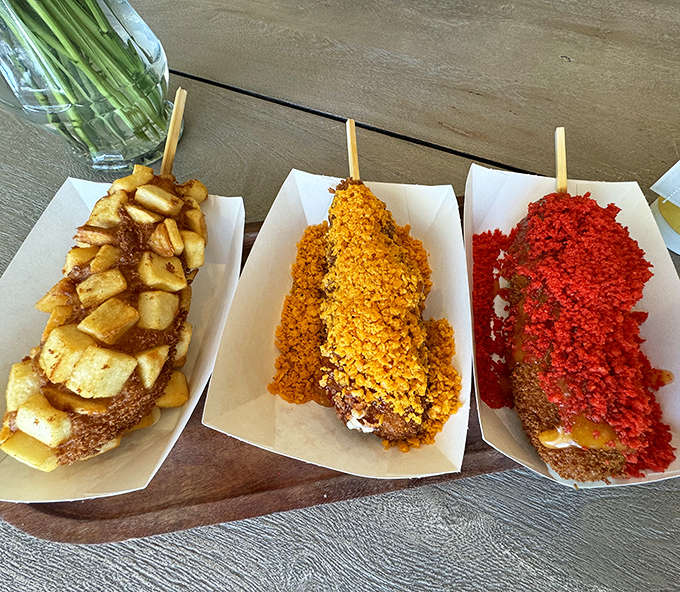Korean corn dogs dressed up in potato cubes and hot chip coatings, because regular corn dogs were apparently feeling underdressed.