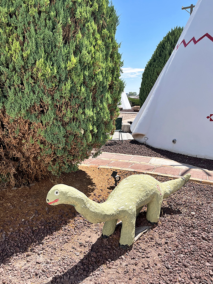 Whimsical concrete dinosaurs lurk between teepees, adding another layer of roadside kitsch to this beloved Route 66 landmark.