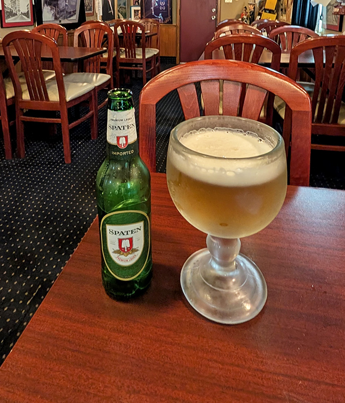 A proper goblet of Spaten beer catches the light in this vintage train car &ndash; proof that simple pleasures are often the most satisfying.