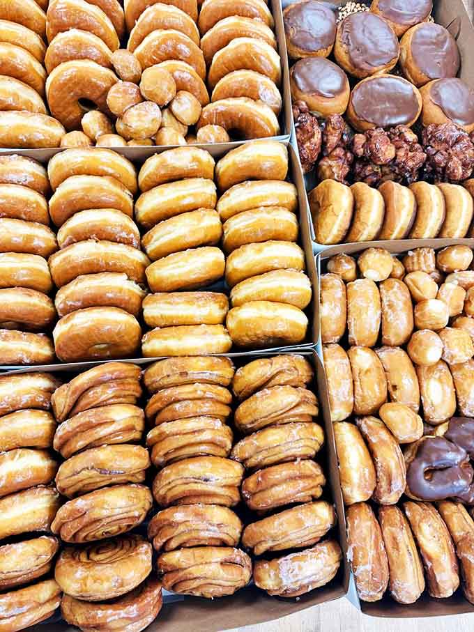 A box of assorted treasures presents the ultimate morning dilemma &ndash; which circular masterpiece deserves the honor of being devoured first?