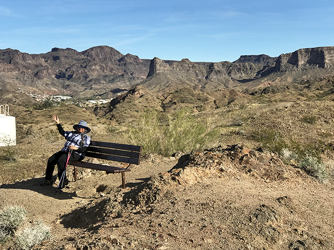 A moment of contemplation on Lightning Bolt Trail, where hikers are rewarded with panoramic views worth every drop of sweat.