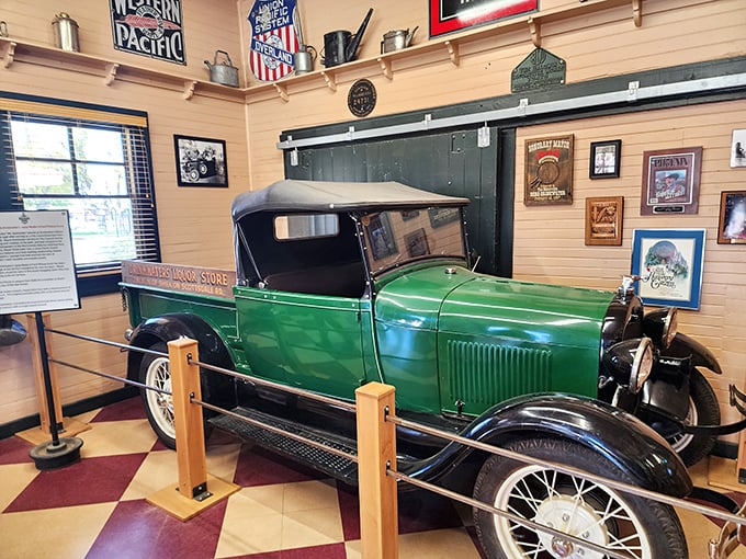 This lovingly preserved vintage automobile sits proudly in the museum, a gleaming green reminder of transportation history beyond the railways.