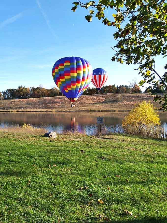 Hot air balloons drift like colorful dreams across the morning sky, adding man-made magic to an already enchanting landscape.
