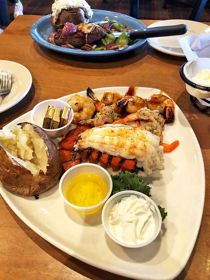 Seafood lovers rejoice! Lobster tail, succulent shrimp and flaky fish share space with a perfectly baked potato.