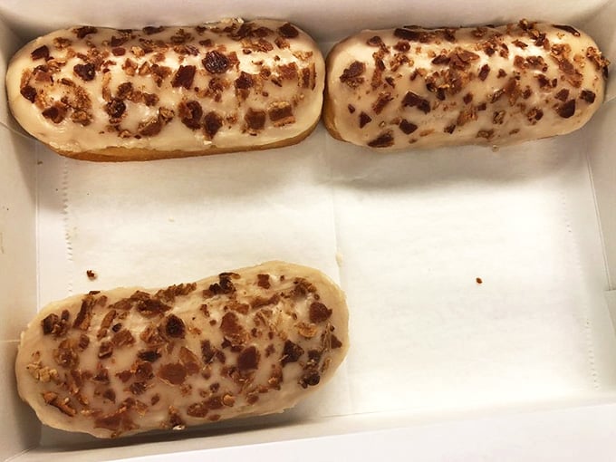 Maple bacon long johns offer the ultimate sweet-savory indulgence, with crispy bacon bits clinging to sticky maple glaze atop pillowy dough.