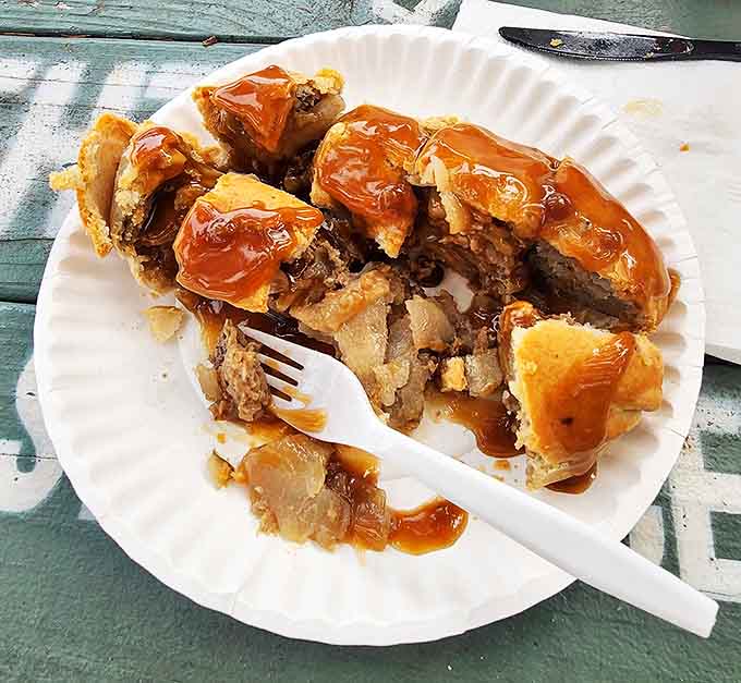 The money shot: a half-eaten pasty reveals its hearty interior of meat and vegetables, a meal that sustained miners and now delights food pilgrims.