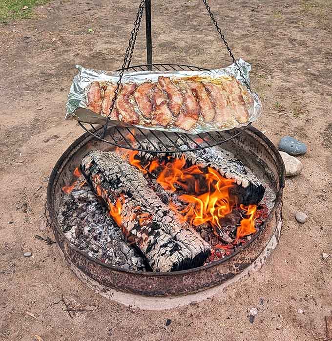 Dinner and a view: Bacon sizzling over an open flame &ndash; the kind of outdoor cooking that makes everything taste better than any five-star restaurant.