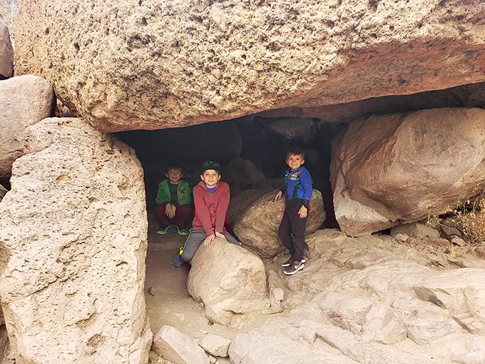 Kids discovering nature's playground&mdash;where rock formations become fortresses and every shadow holds potential for adventure.