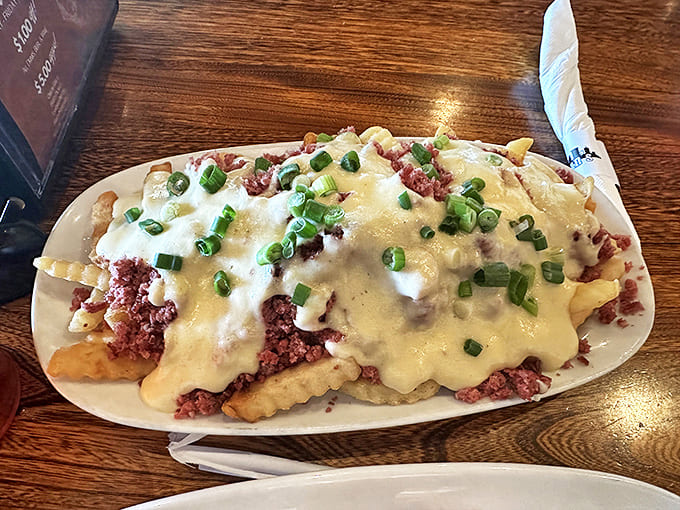 Sly Fries: where corned beef, cheese sauce, and green onions transform humble potatoes into a Cleveland-style poutine that demands a fork and your respect.