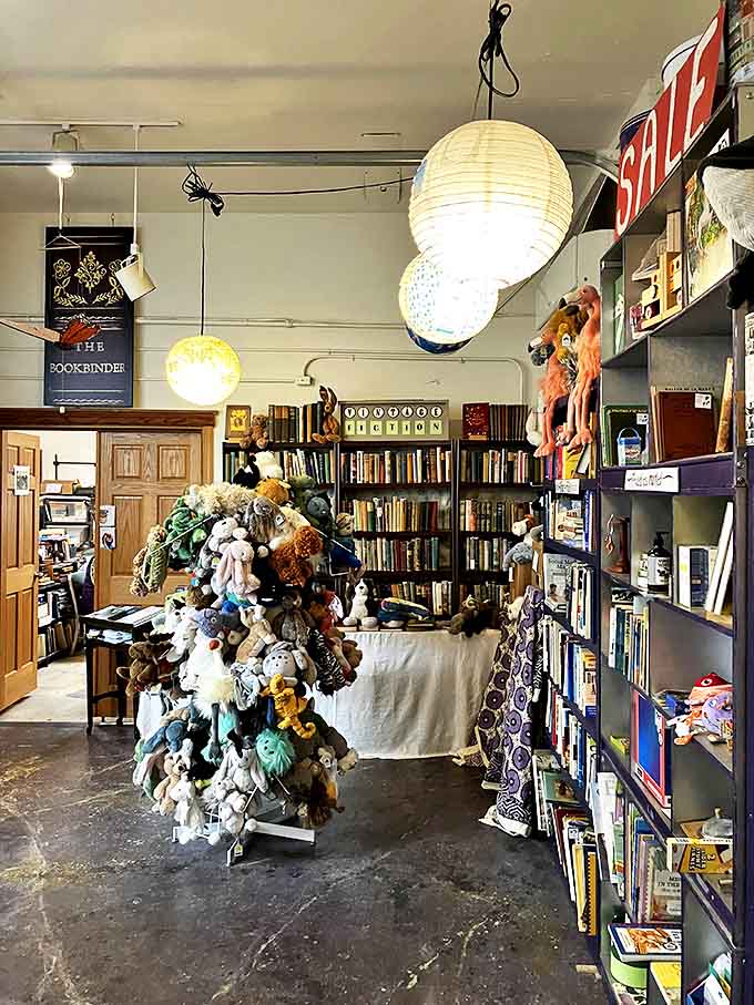 The whimsical children's section features a delightful display of stuffed animals alongside carefully selected books for young readers.